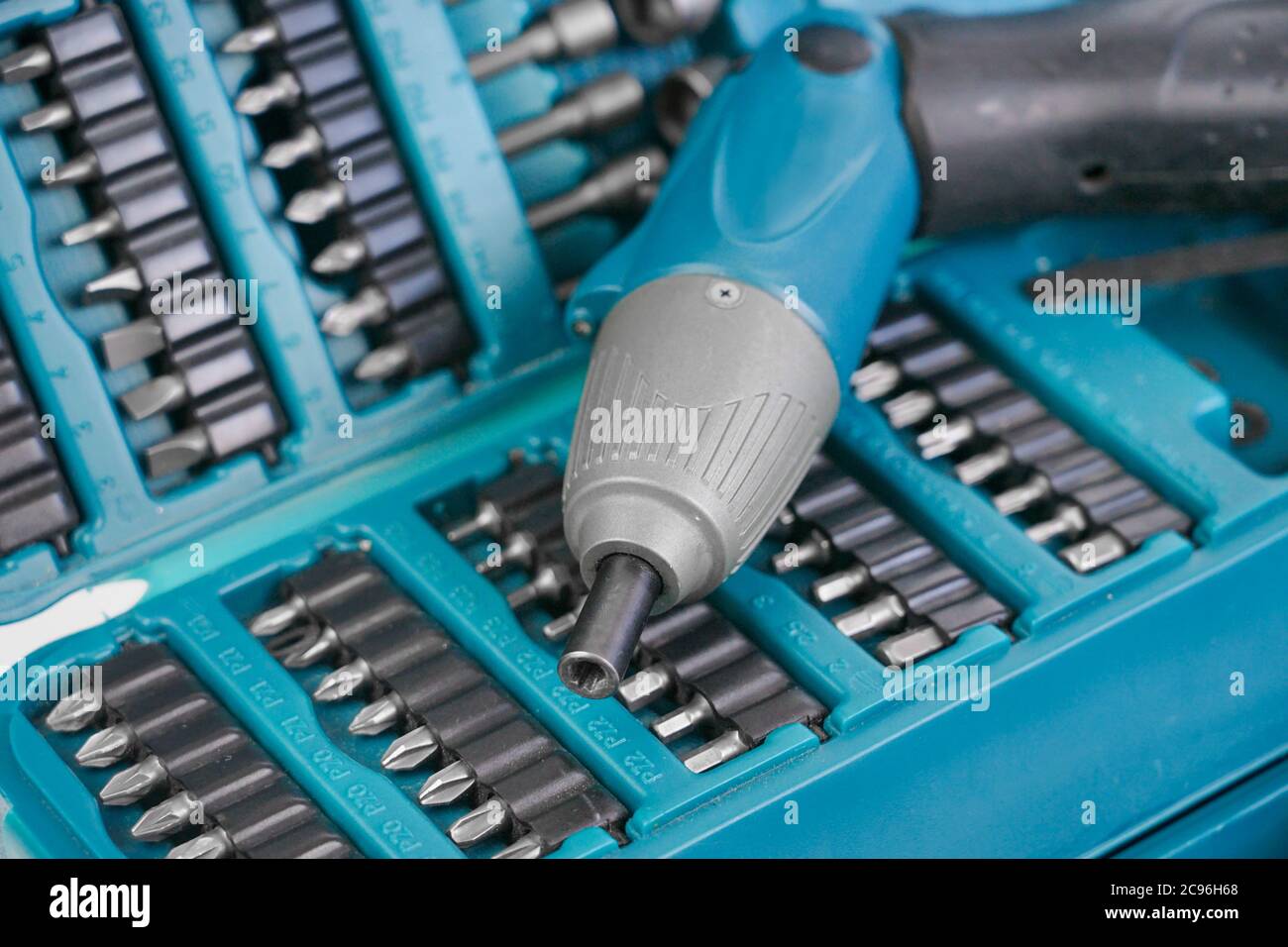 Electric screwdriver lies next to the drawer with a set of screwdrivers ...