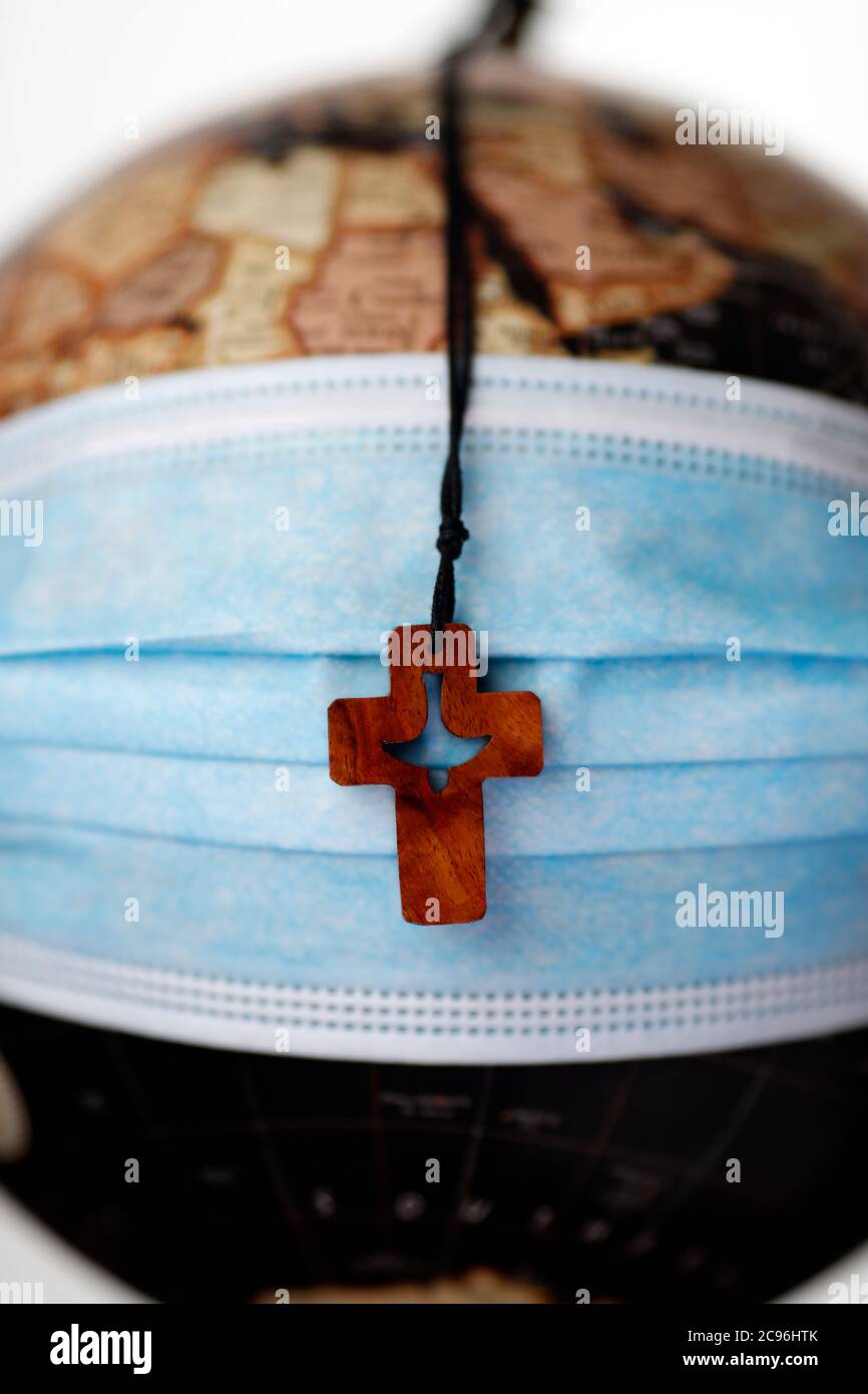 Coronavirus (COVID-19) epidemic. Holy spirit cross on a blue disposable ...