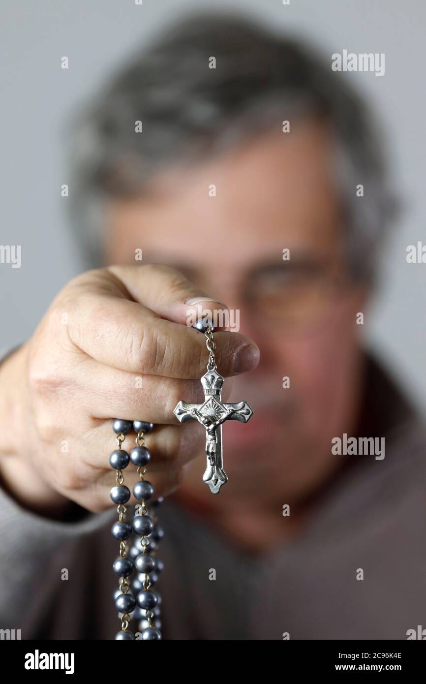Man praying the Rosary. Close-up on hand. France Stock Photo - Alamy