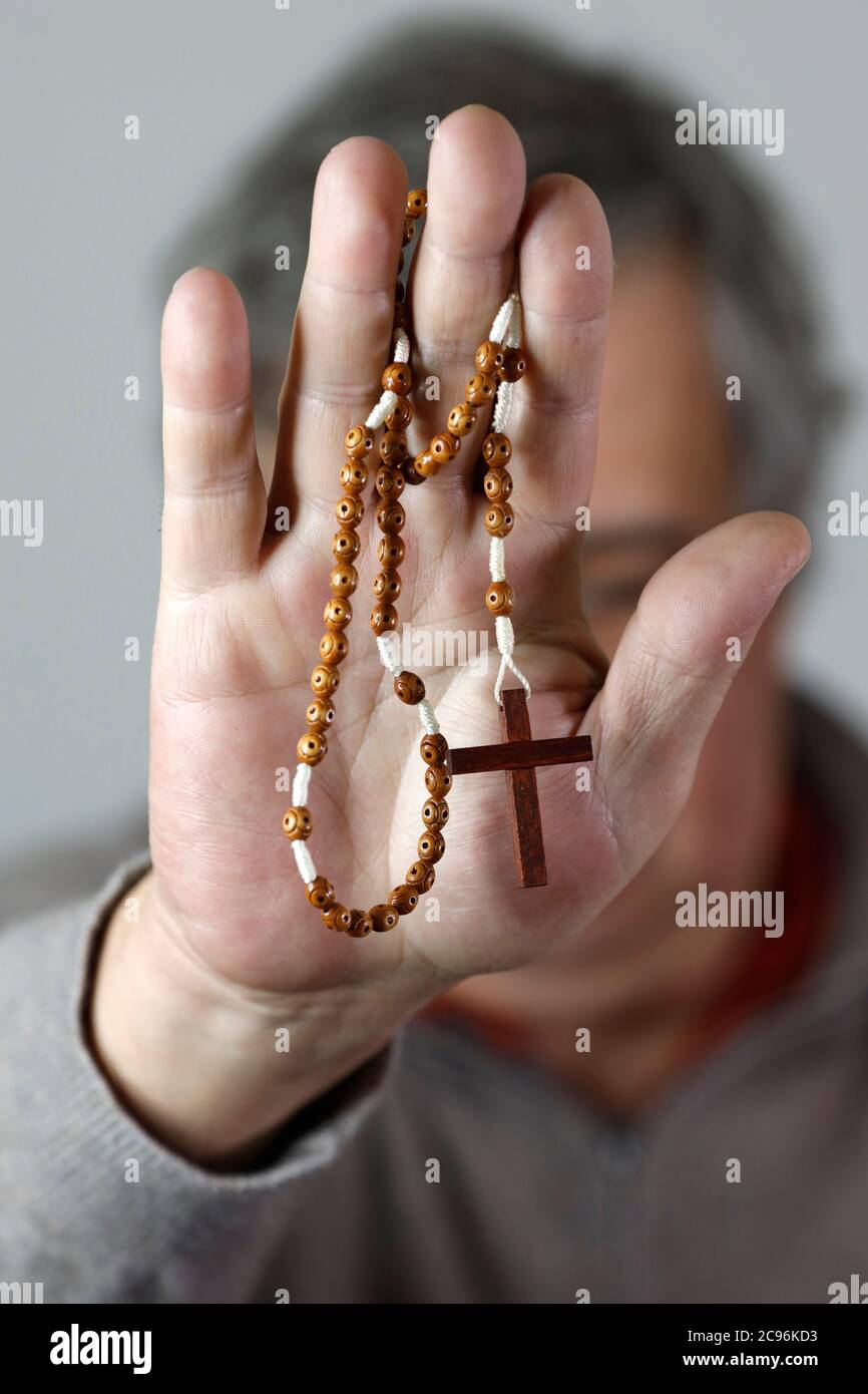 Man praying the Rosary. Close-up on hand. France Stock Photo - Alamy