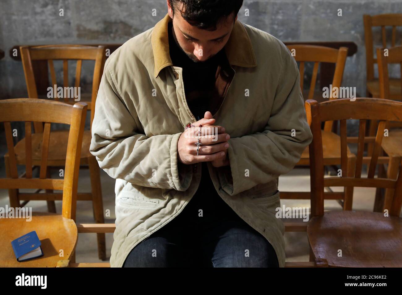 Young man praying in church hi-res stock photography and images - Alamy
