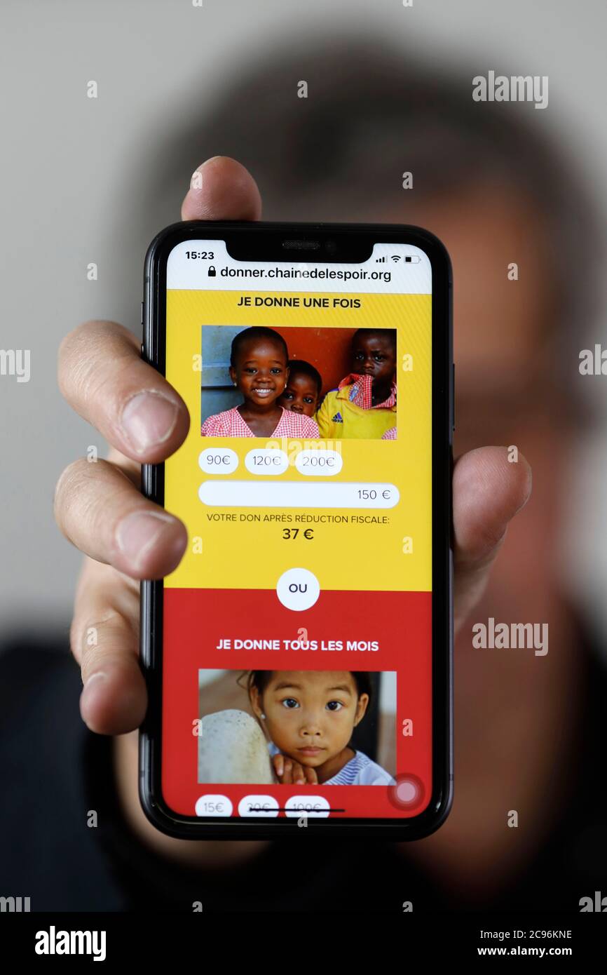 Fundraising on a smartphone for the Chain of Hope. French NGO. France ...