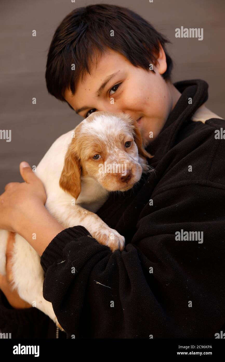 Child holding puppy hi-res stock photography and images - Alamy