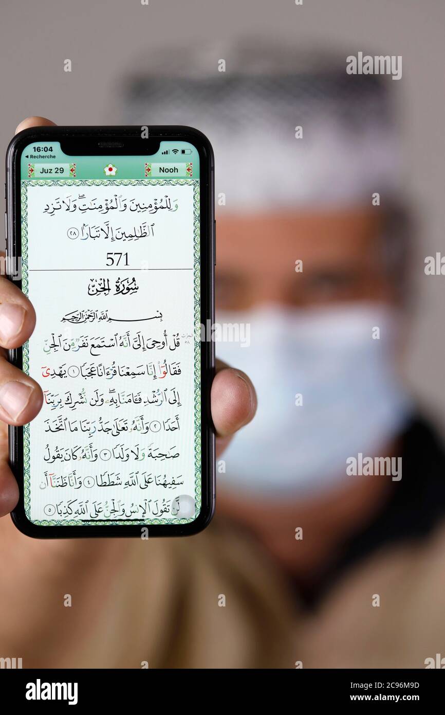 Man showing an electronic Quran on a smartphone. France Stock Photo - Alamy