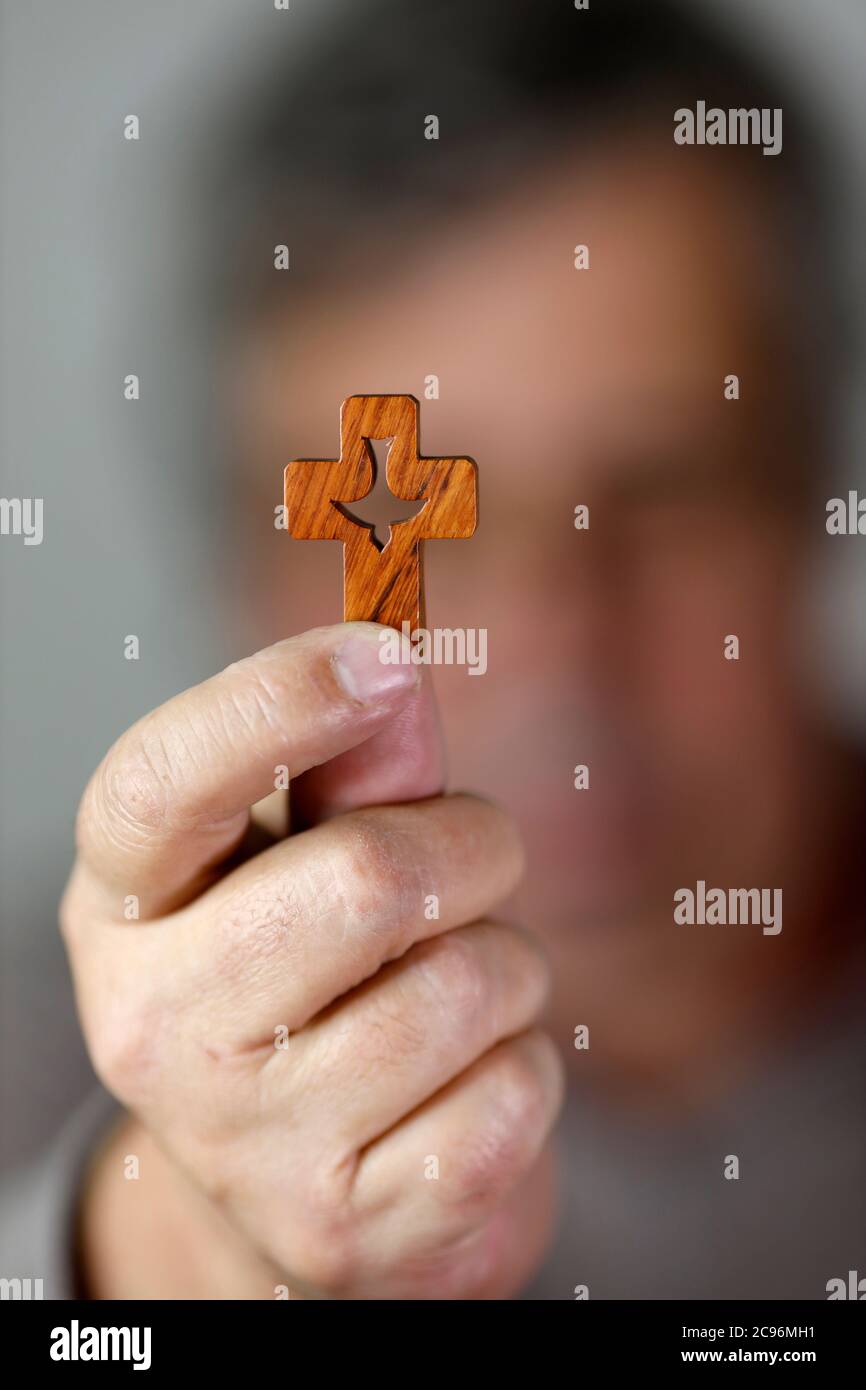 Man with a holy spirit cross. Close-up on hand. France Stock Photo - Alamy