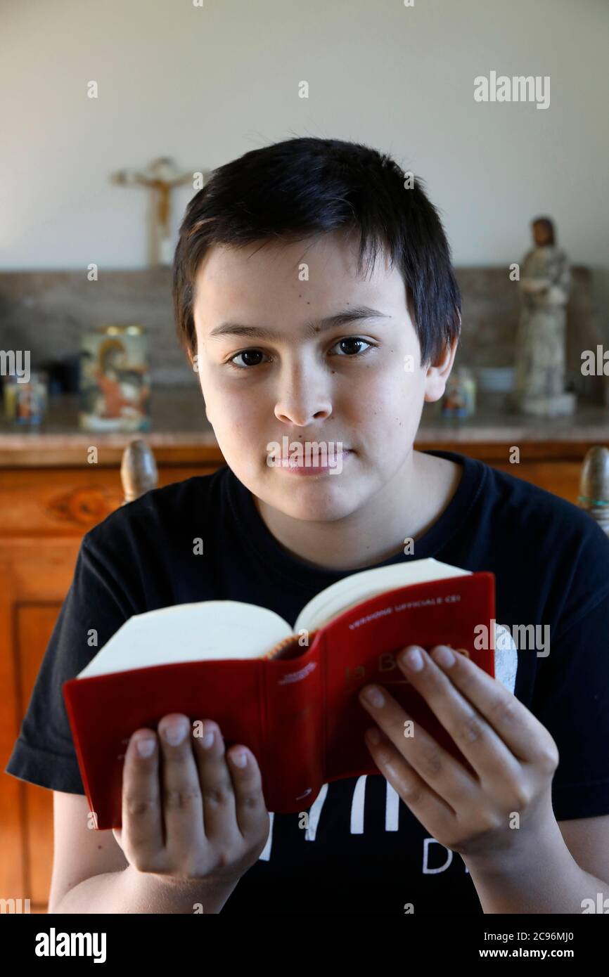 Boy reading the bible at home in Eure, France Stock Photo - Alamy