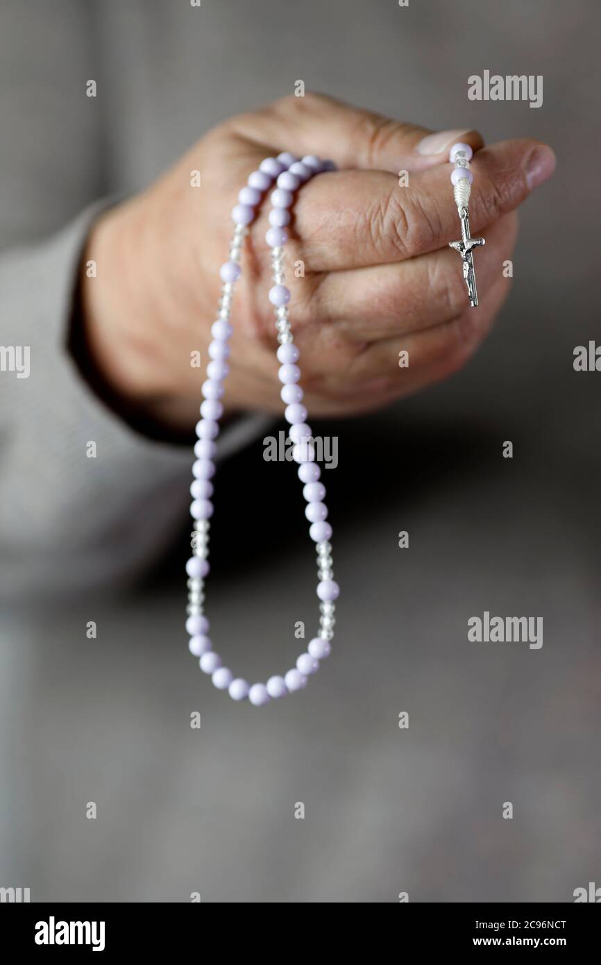 Man praying the Rosary. Close-up on hand. France Stock Photo - Alamy
