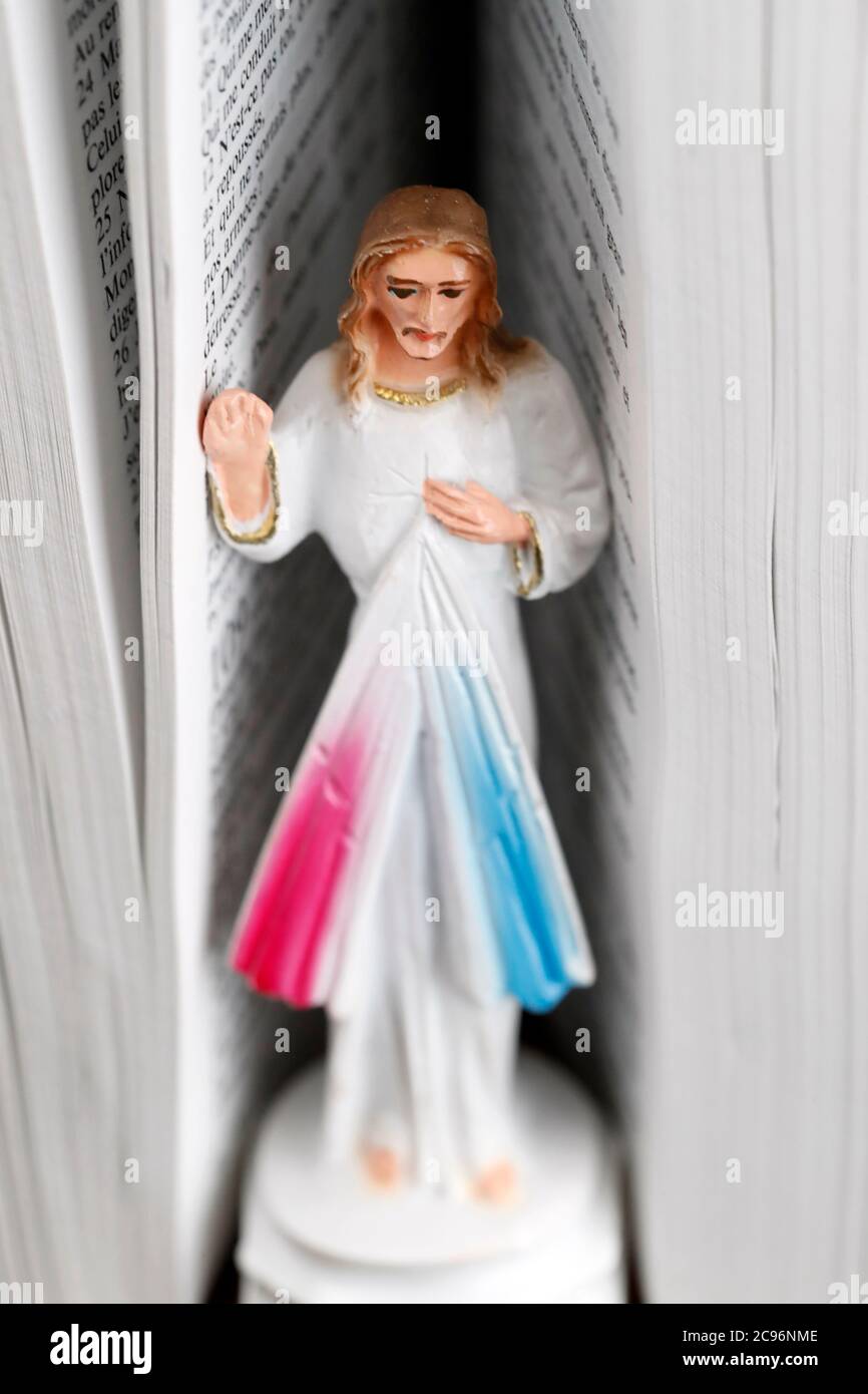 Jesus statue against an open bible. France Stock Photo - Alamy