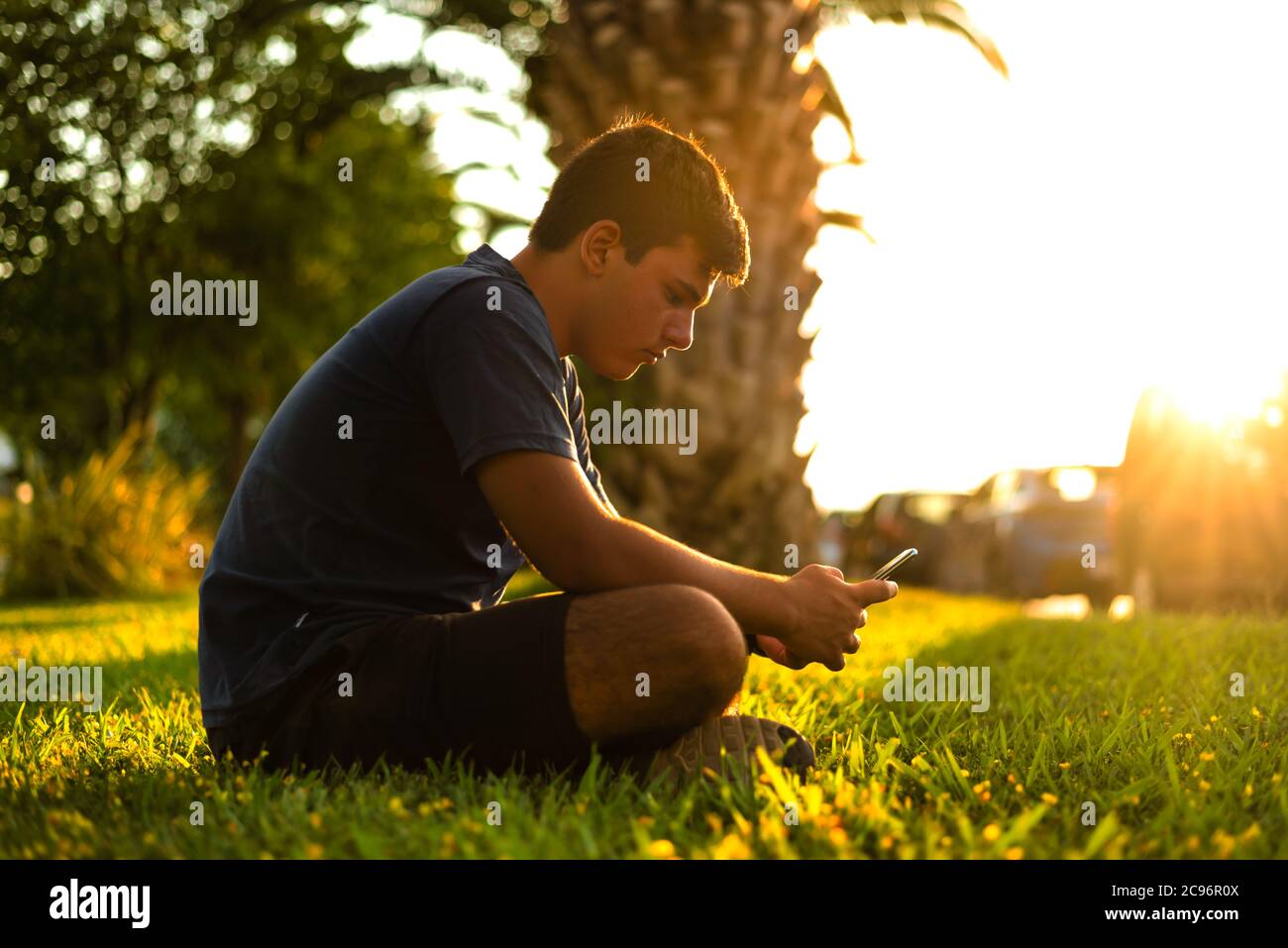 Teenage Boy Using Phone In Urban Setting Stock Photo - Alamy