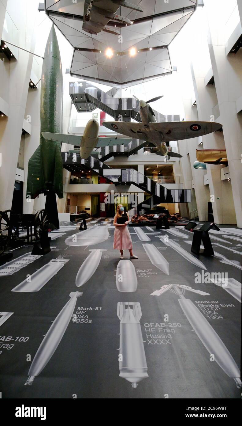 An Imperial War Museum member of staff stands on part of the surface of ...