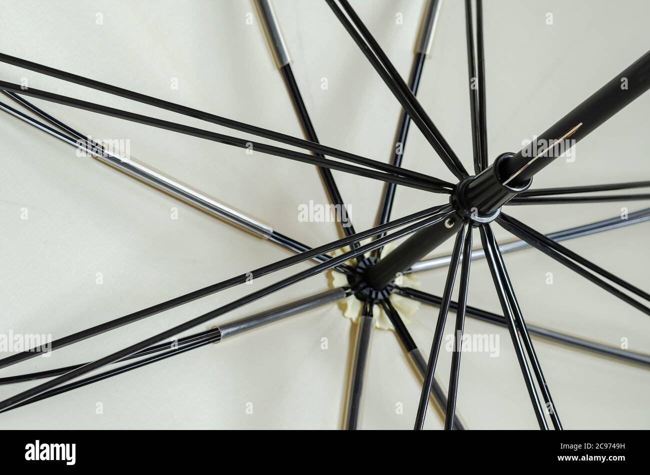 Details of the inside of the umbrella. Close-up of a beige umbrella ...