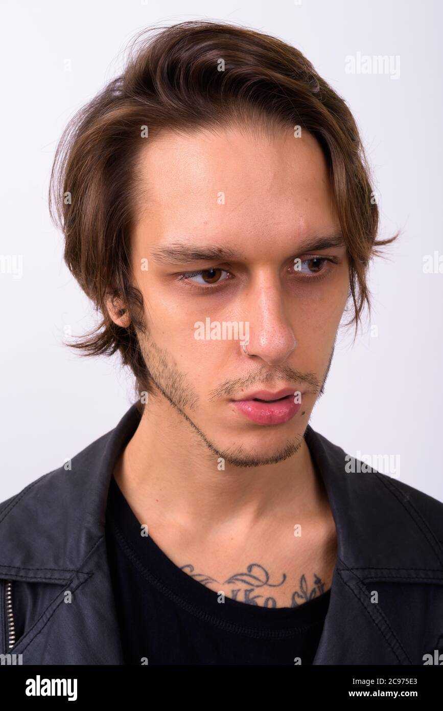 Young handsome rebellious man against white background Stock Photo - Alamy