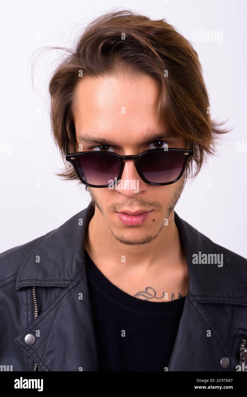 Young handsome rebellious man against white background Stock Photo - Alamy