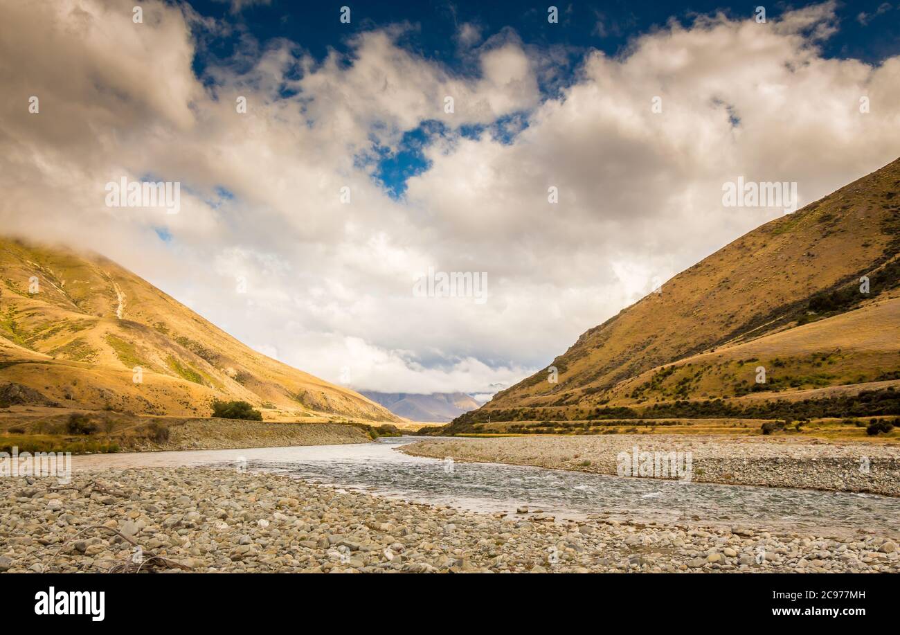 A New Zealand mountain stream, the Ahuriri River, in a V shaped valley ...