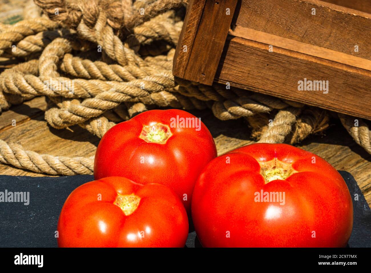 Close up of fresh ripe tomatoes isolated in a rustic composition Stock ...