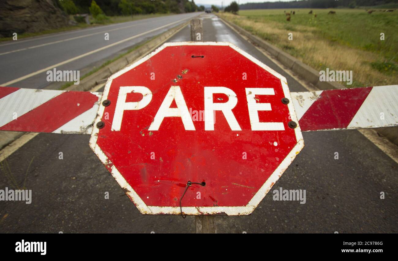 High angle shot of a red damaged PARE sign on the road Stock Photo - Alamy