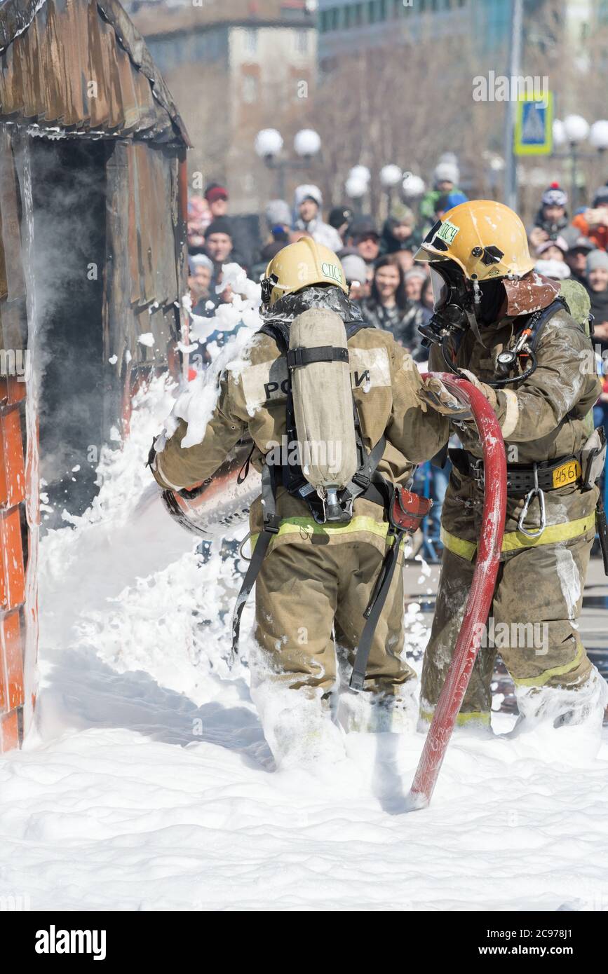 Firefighters MChS extinguishing fire from fire hose, using fire ...