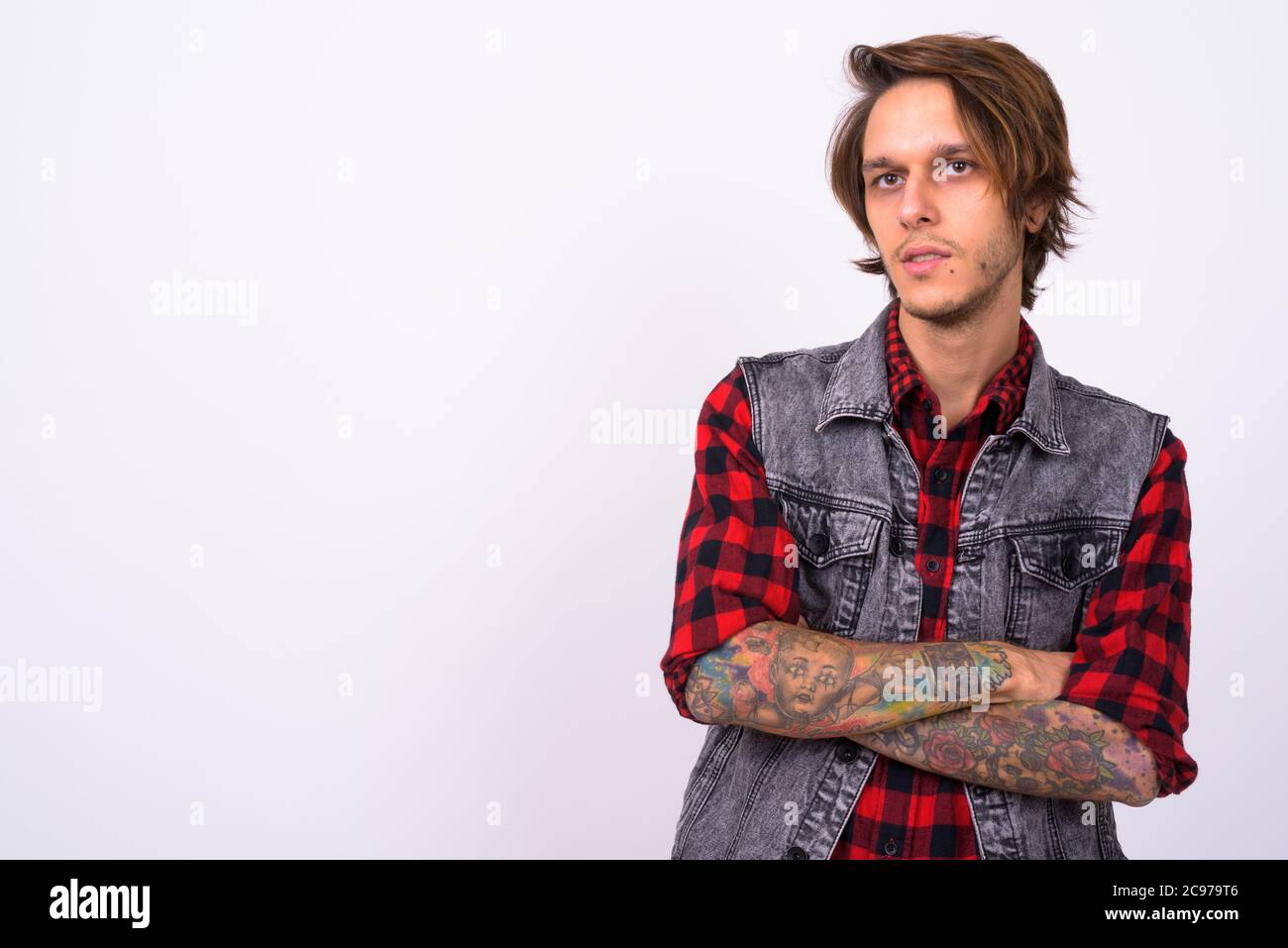 Young handsome rebellious man against white background Stock Photo - Alamy