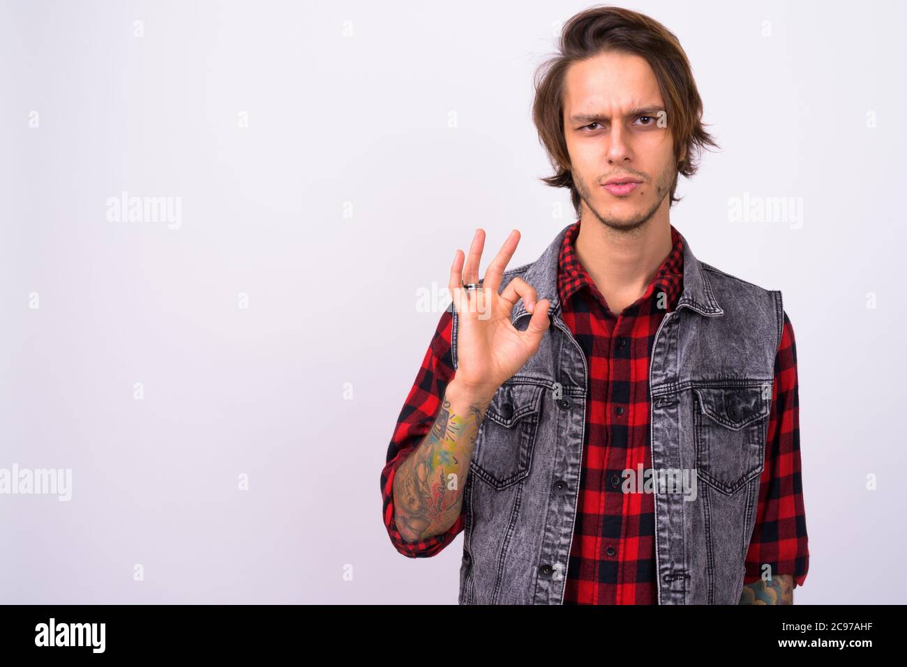 Young handsome rebellious man against white background Stock Photo - Alamy