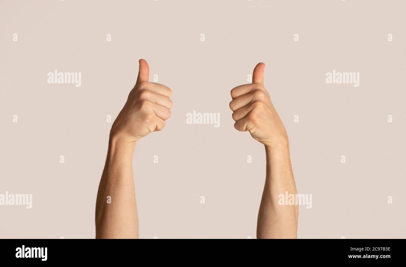 Unrecognizable man showing thumbs up gesture, expressing approval over ...