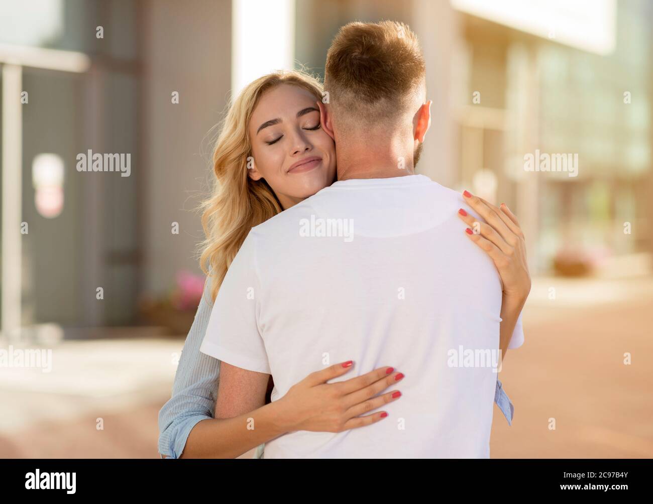Affectionate couple cuddling, walking down the streets Stock Photo - Alamy