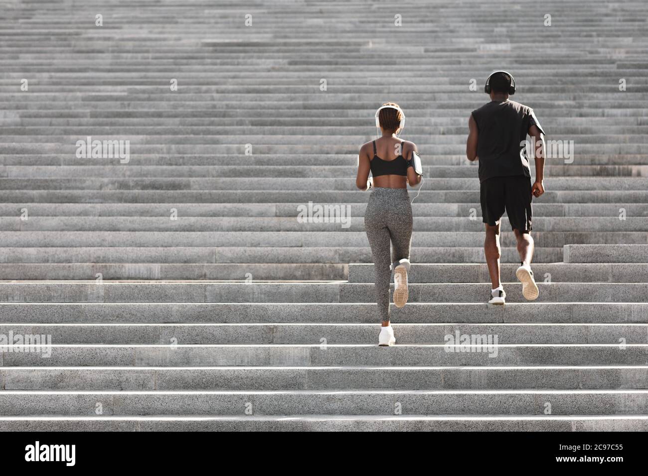 Black man running up stairs hi-res stock photography and images - Alamy