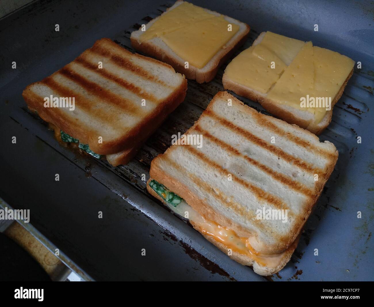 sandwiches on a frying pan grill in kitchen fried Stock Photo - Alamy