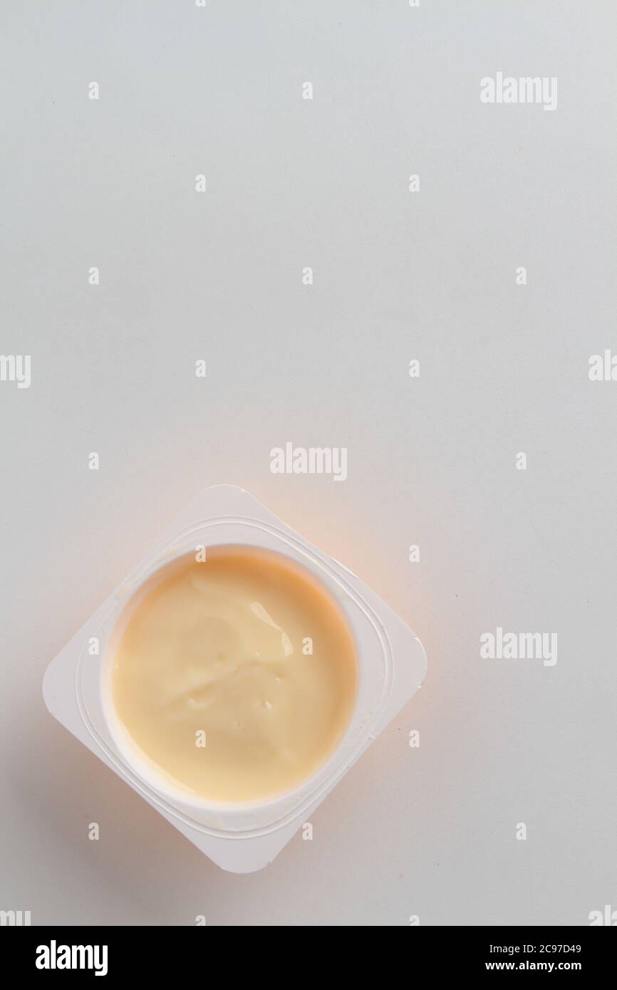 Vertical top view of an opened yogurt on a white surface Stock Photo ...