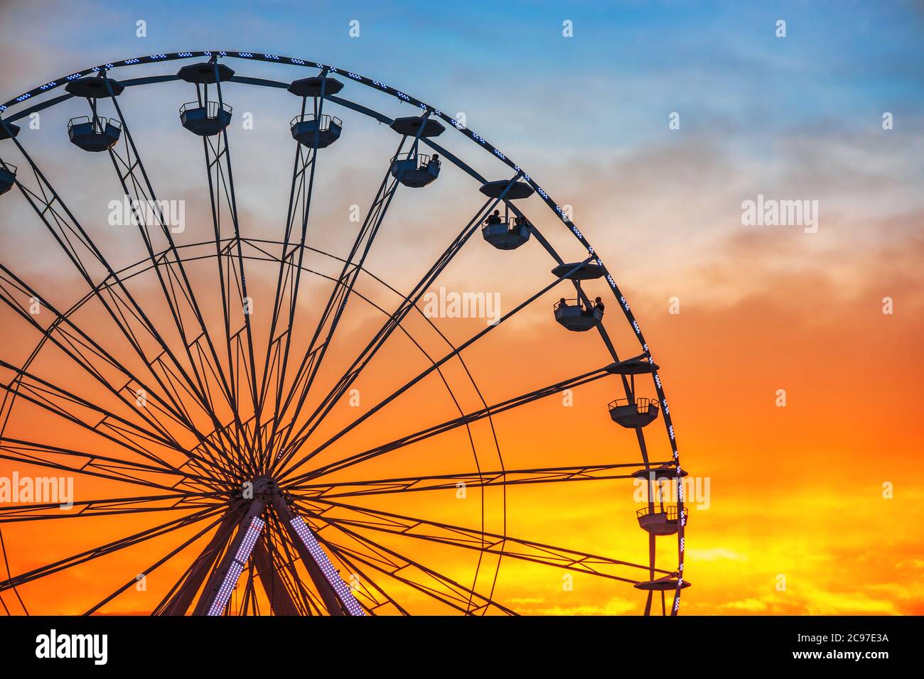 Ferris Wheel with sunset sky and clouds Stock Photo - Alamy