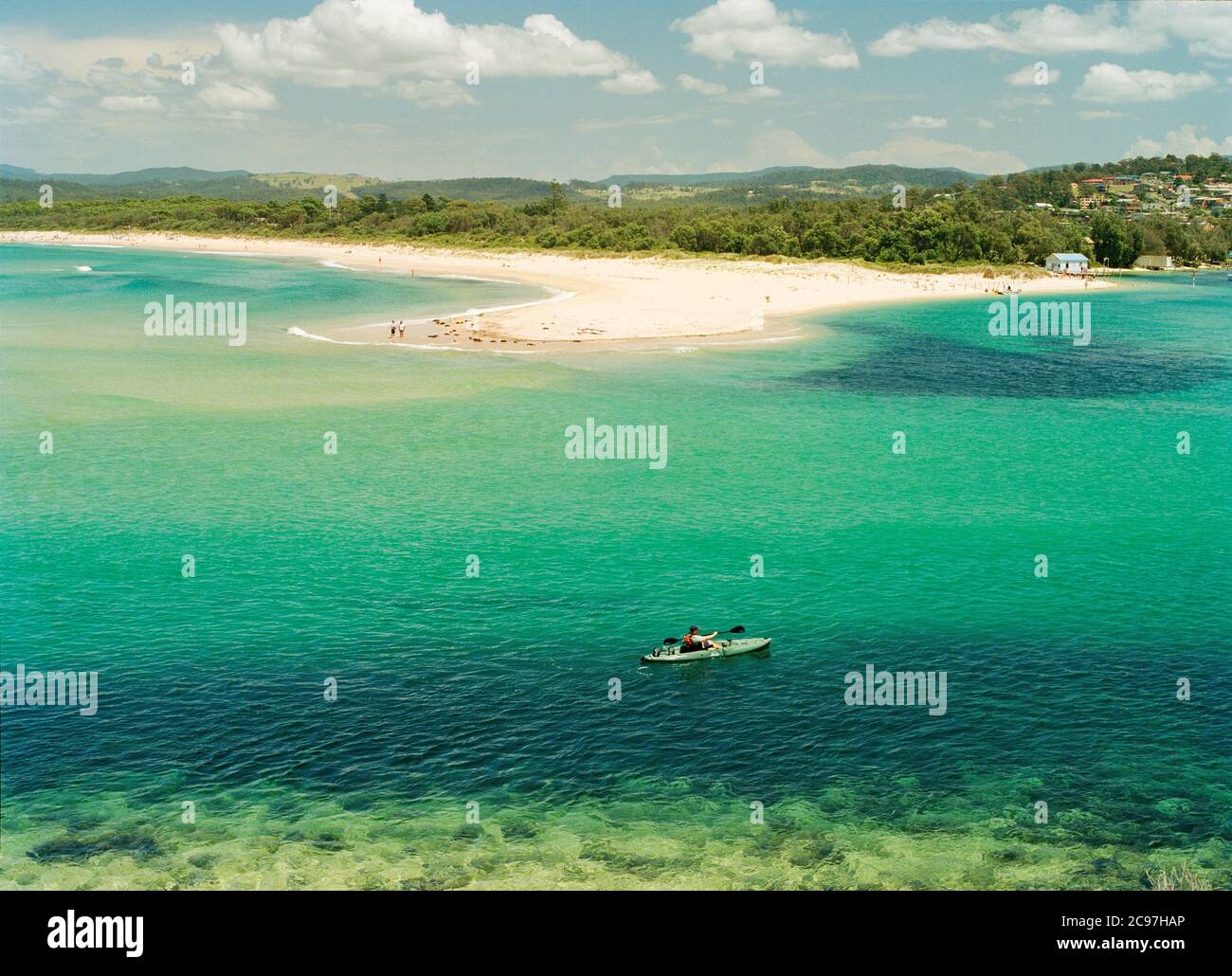 The sand bar and inlet at Merimbula lake with a passing canoe Stock ...