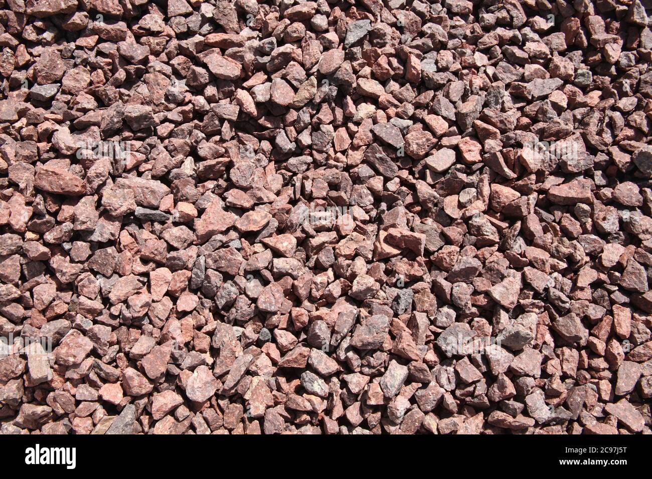 Background texture of pink, crushed quarry rock pebble stones used for ...