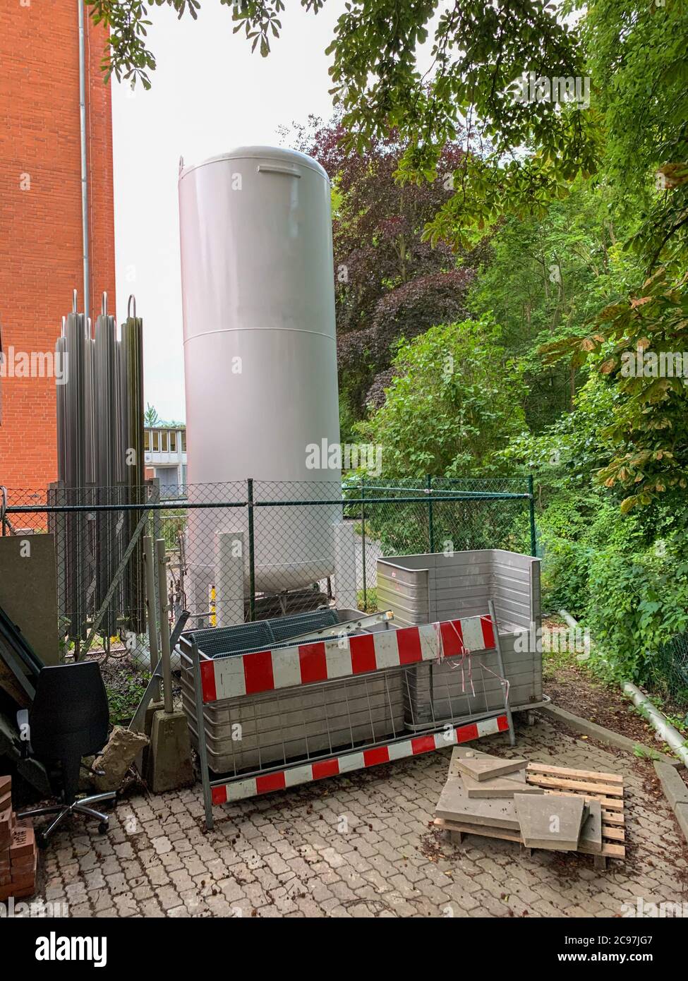 a large white oxygen tank is standing on the grounds of a hospital ...