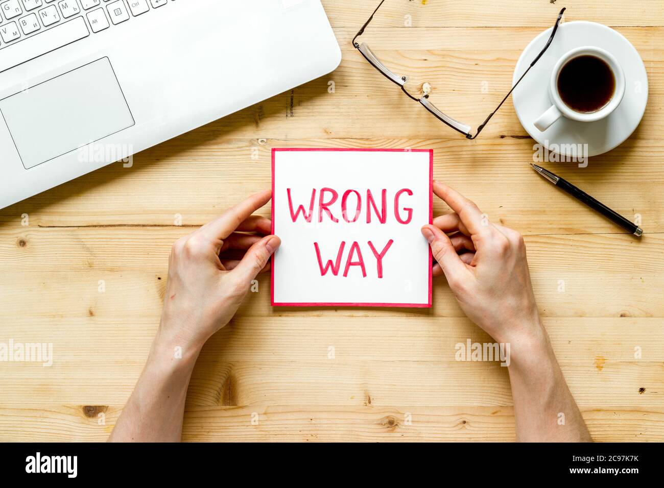 Business failure. Wrong way icon in hands on office desk top-down Stock ...