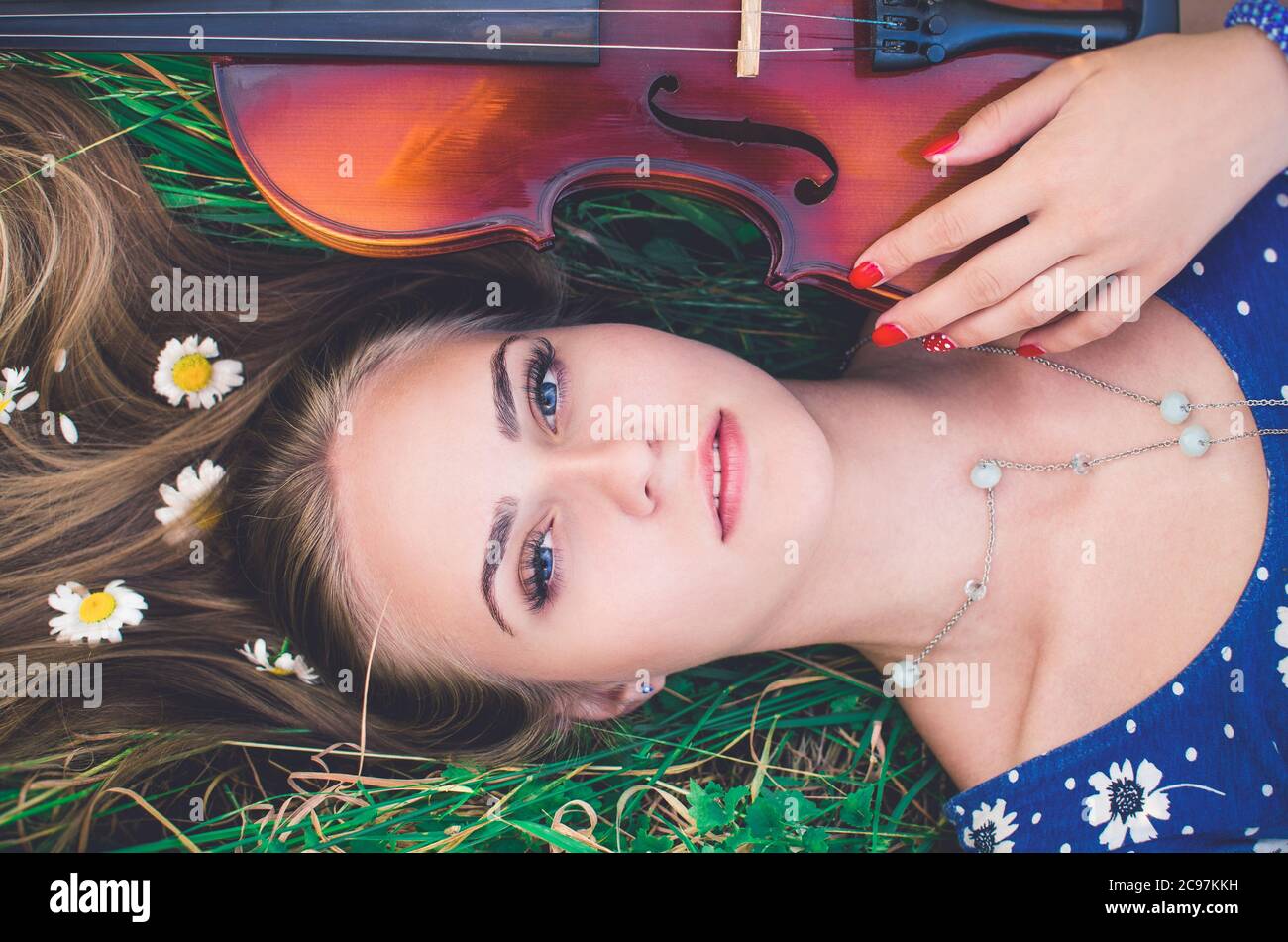 Young Slim Fair Skinned Girl Blonde Beautiful Lies In Tall Grass Top