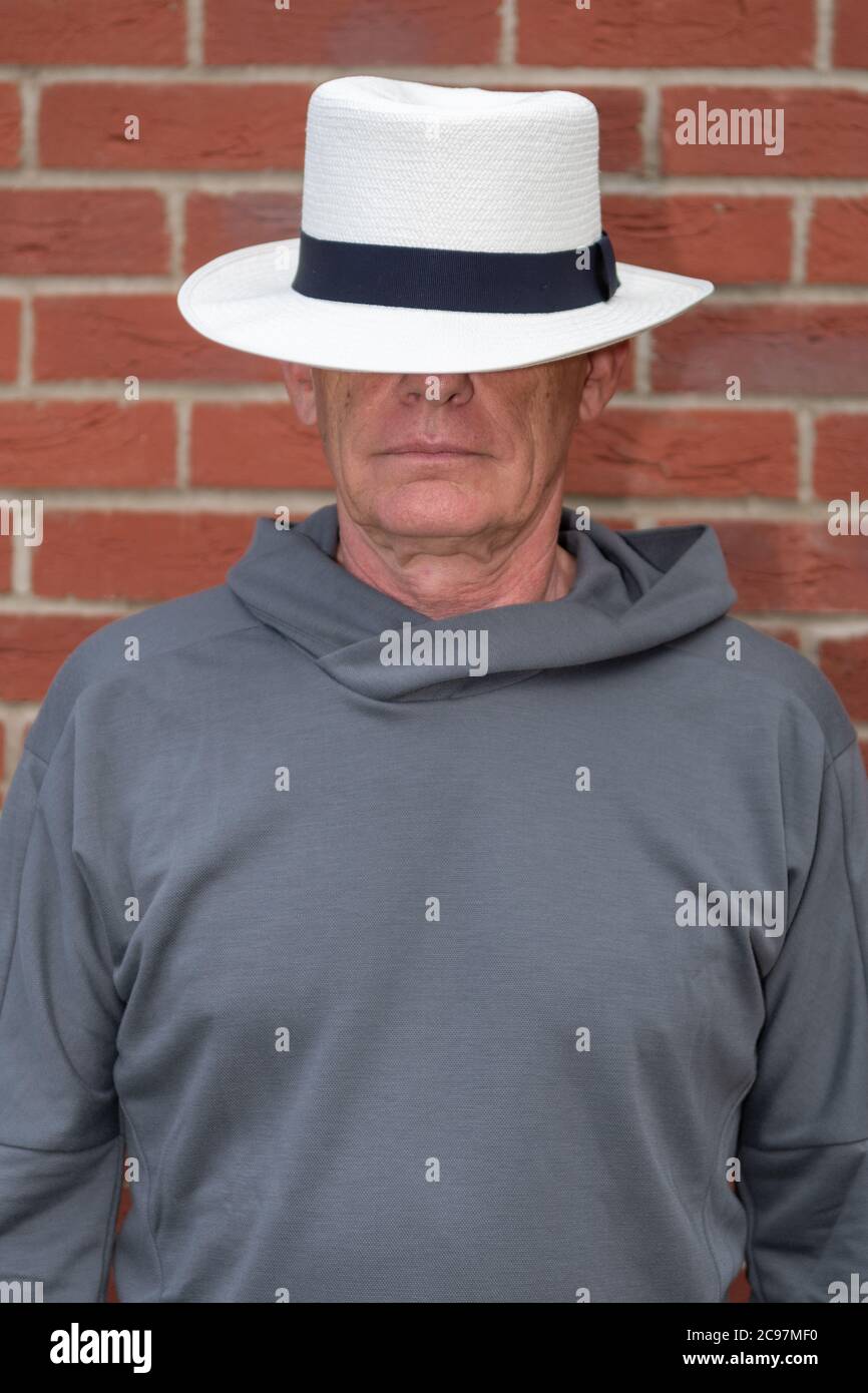 Man in panama hat pulled down over his eyes hi-res stock photography ...