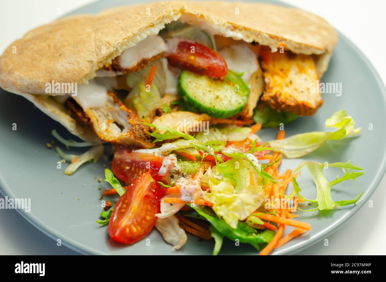 Mediterranean style pitta prepared with spicy chicken, cucumber, tomato ...