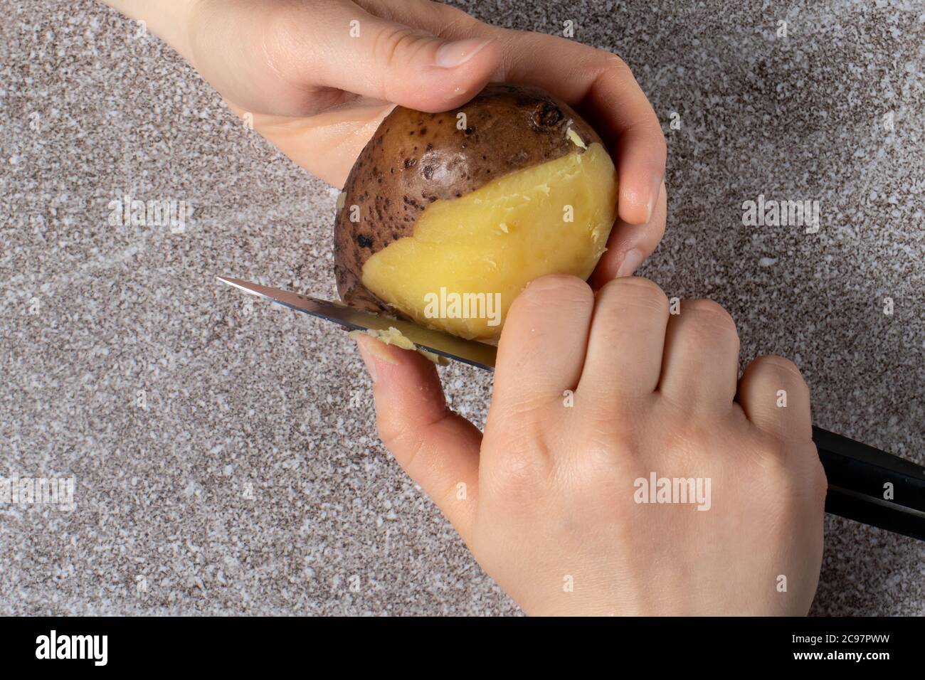 The process of peeling boiled potatoes. Cooking boiled potatoes Stock ...