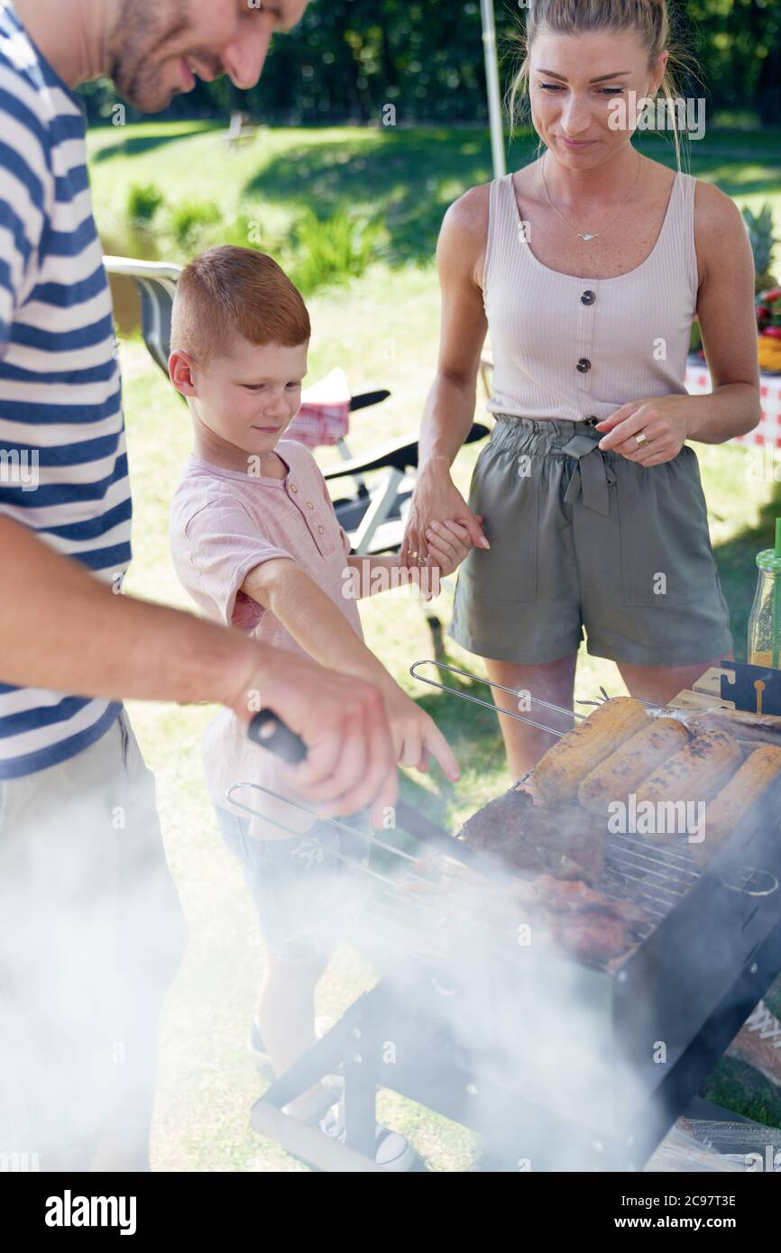 Family having a barbecue in the yard Stock Photo - Alamy
