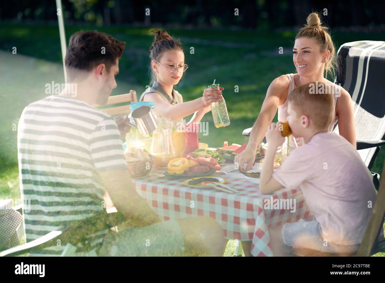 Family spending time on camping at the table Stock Photo - Alamy