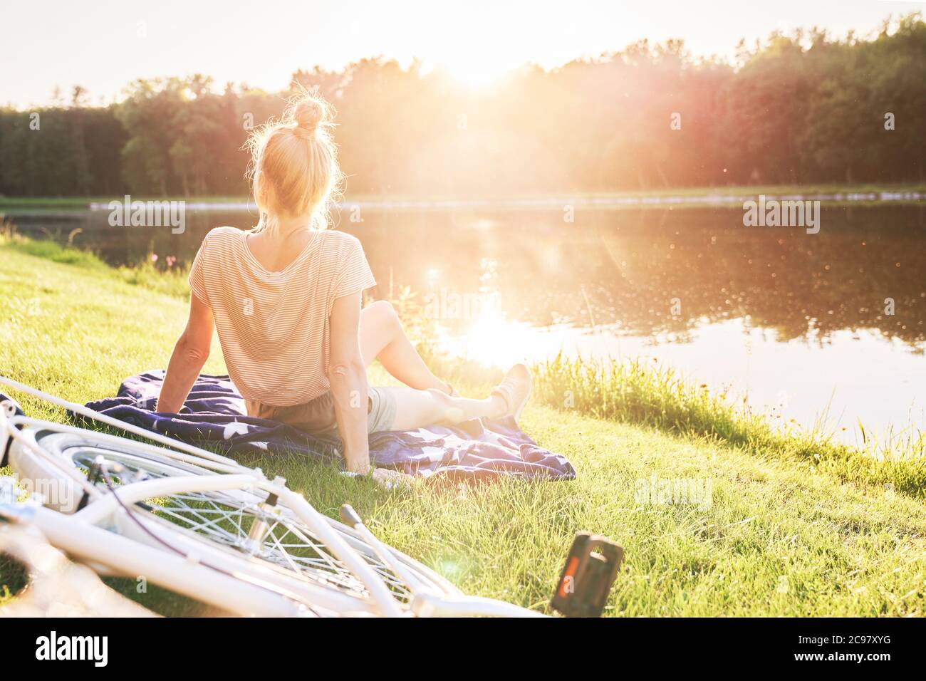Woman relaxing during break at bike ride Stock Photo - Alamy