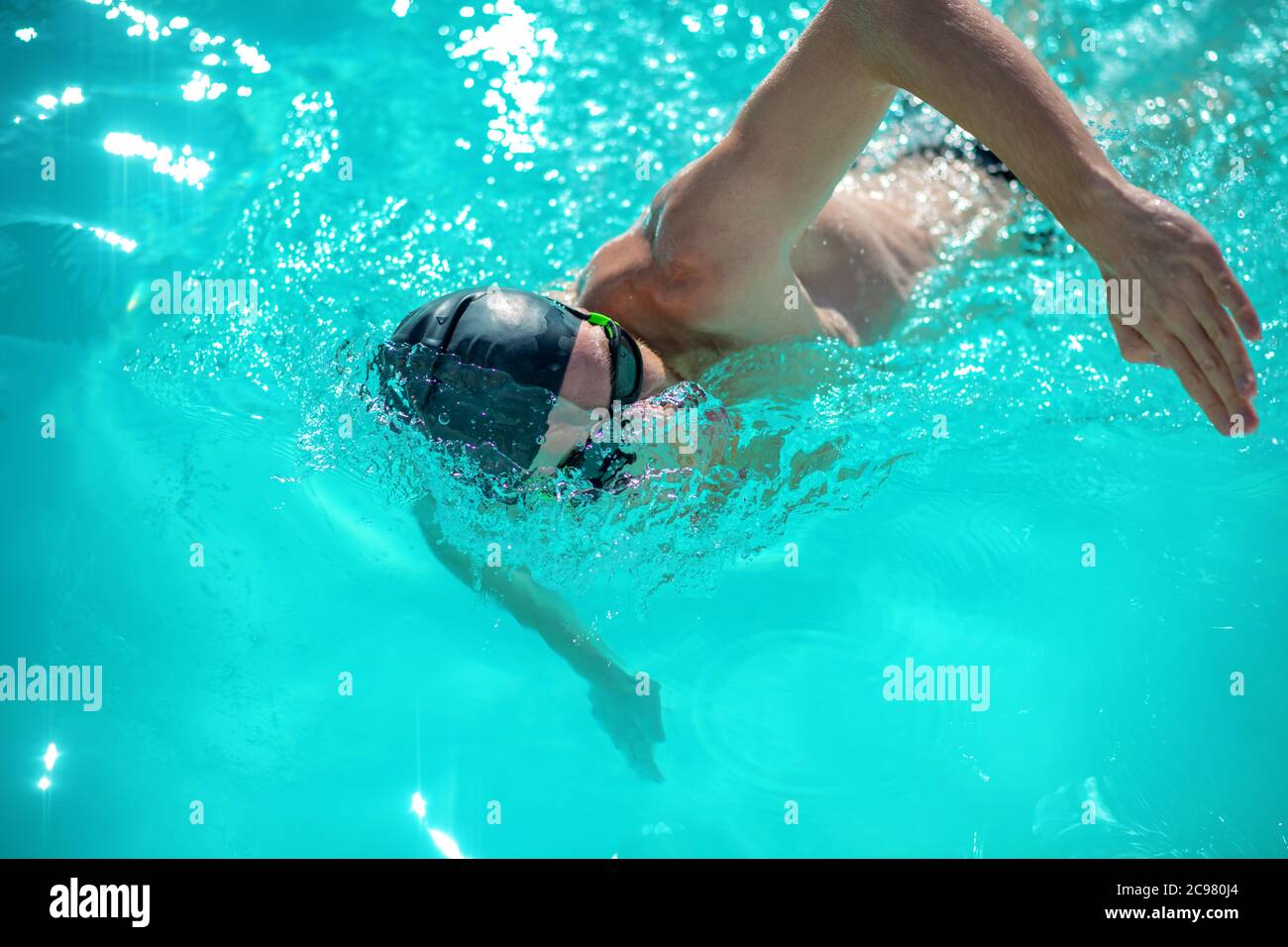 Male swimmer half face and hand above water Stock Photo - Alamy