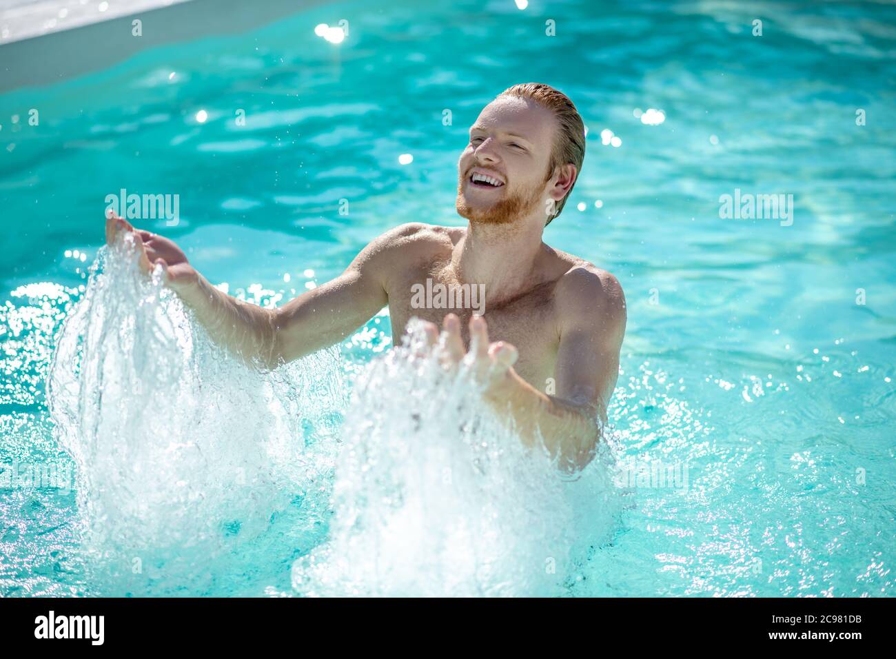 Man standing waist-deep in water in the pool Stock Photo - Alamy