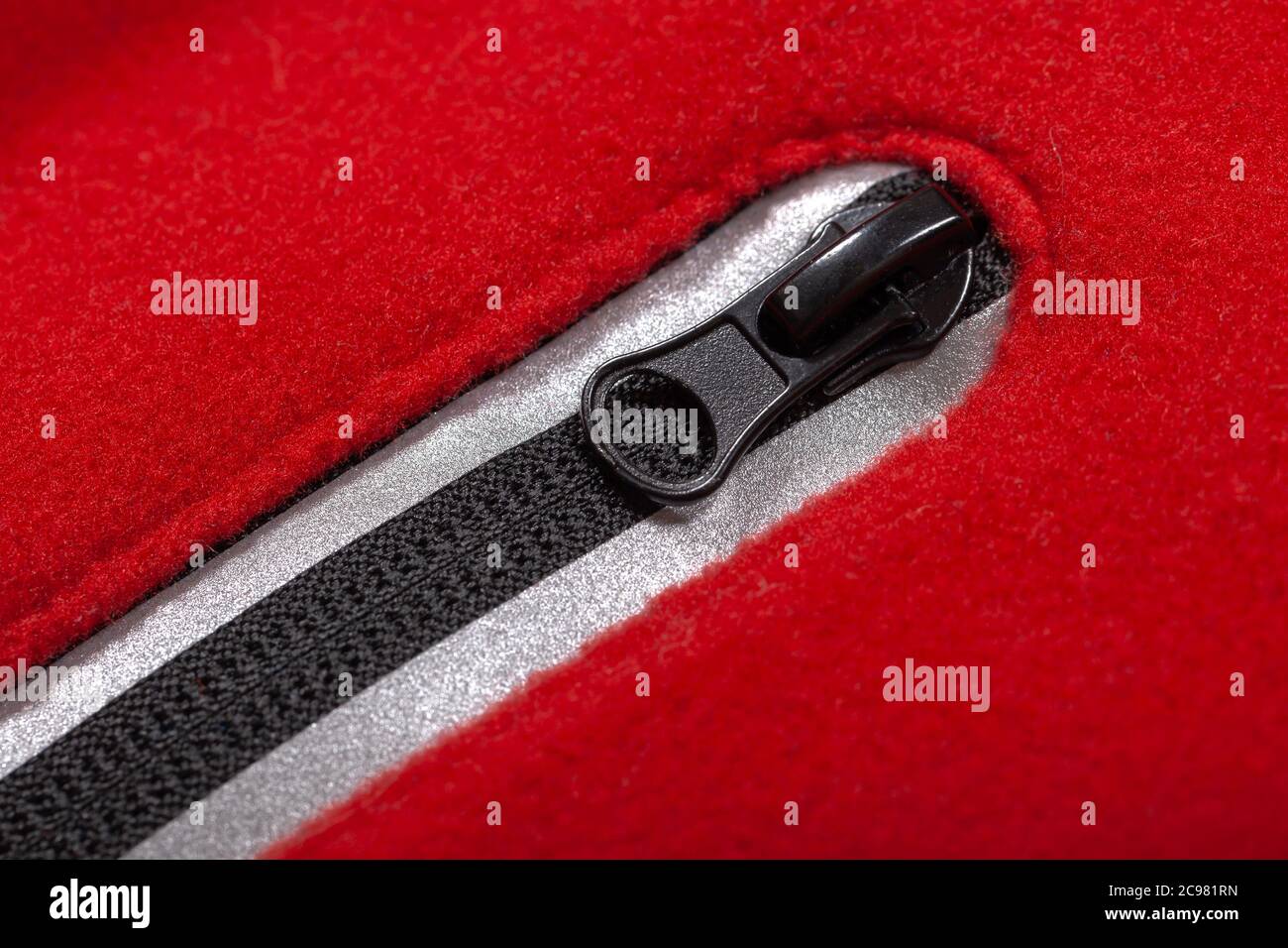 Zipper of a red fleece jacket, close-up photo Stock Photo - Alamy