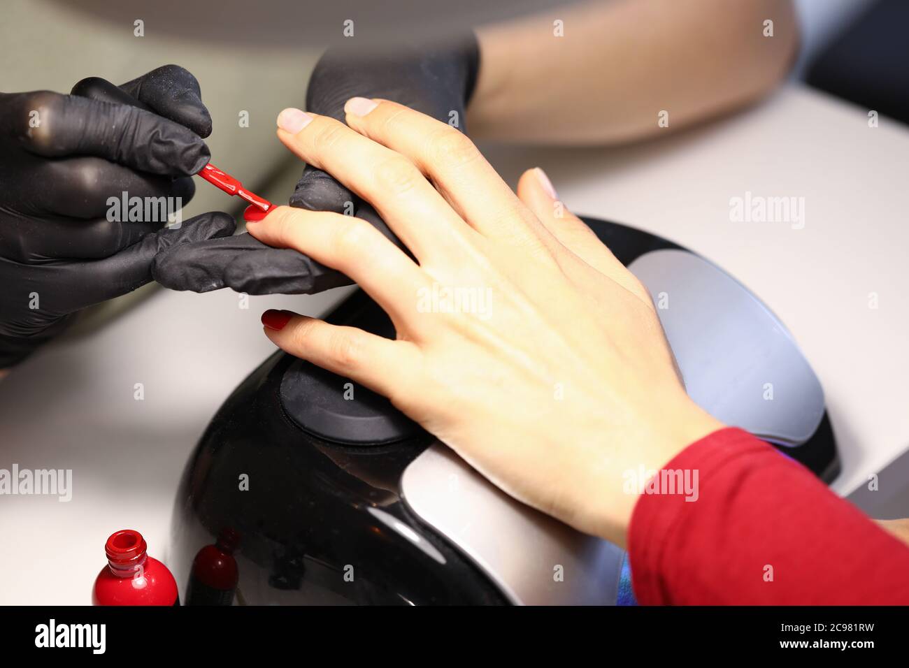 On female nails apply the perfect color of varnish Stock Photo - Alamy