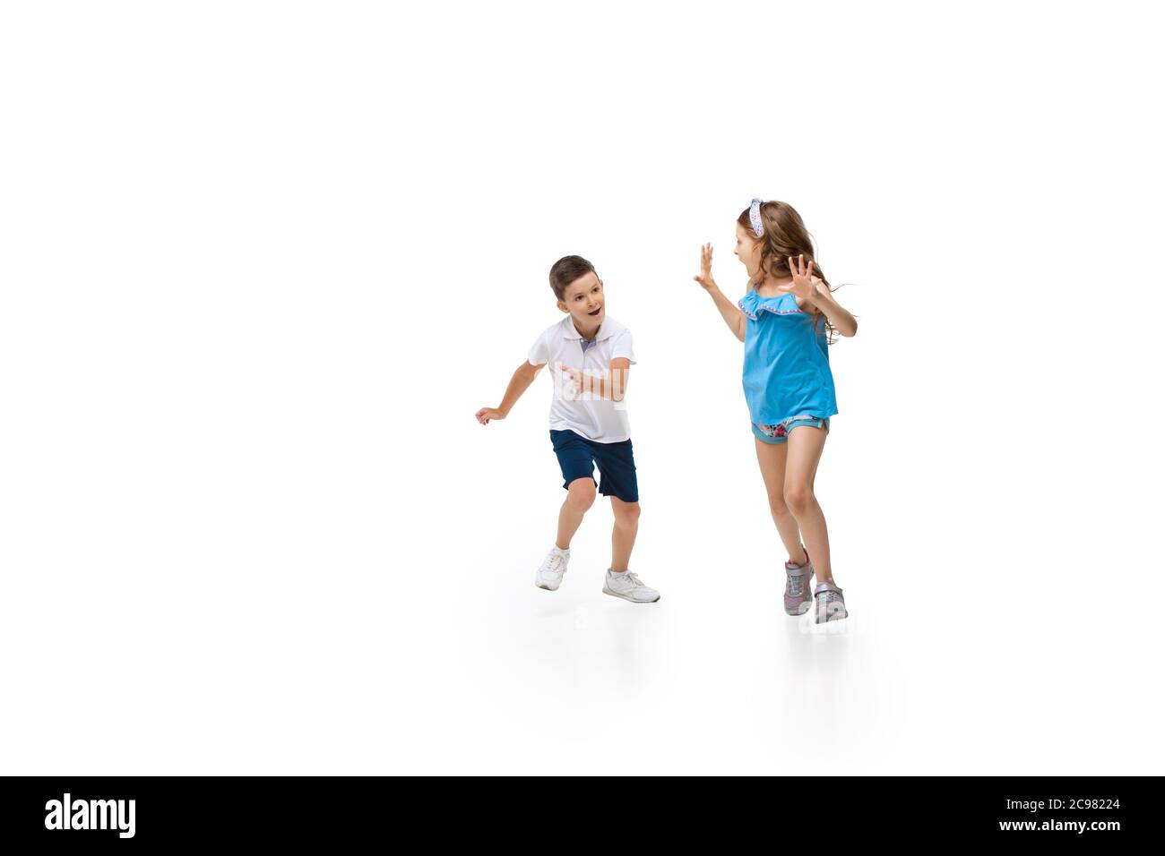 Happy kids, little and emotional caucasian boy and girl jumping and ...