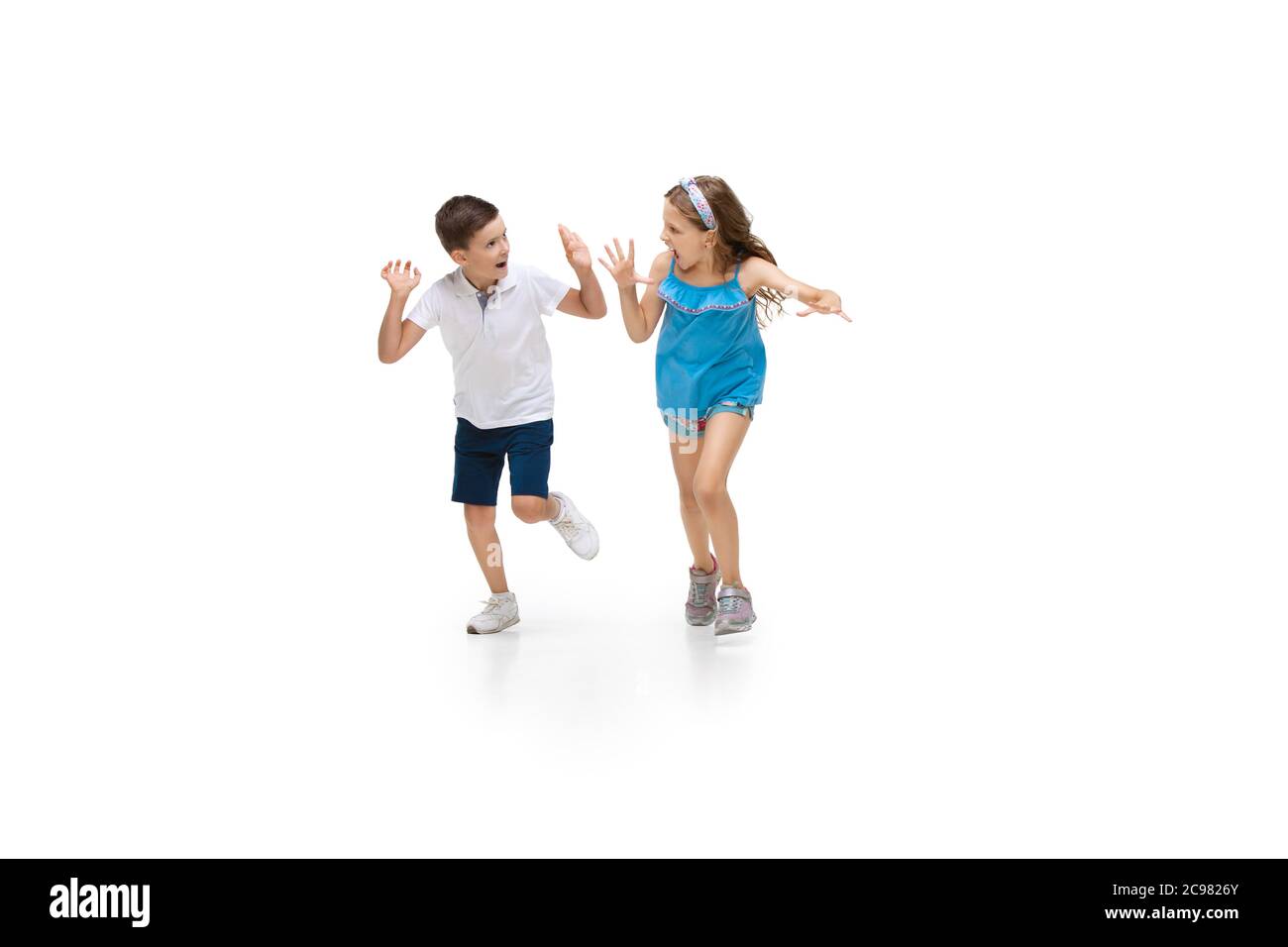 Happy kids, little and emotional caucasian boy and girl jumping and ...