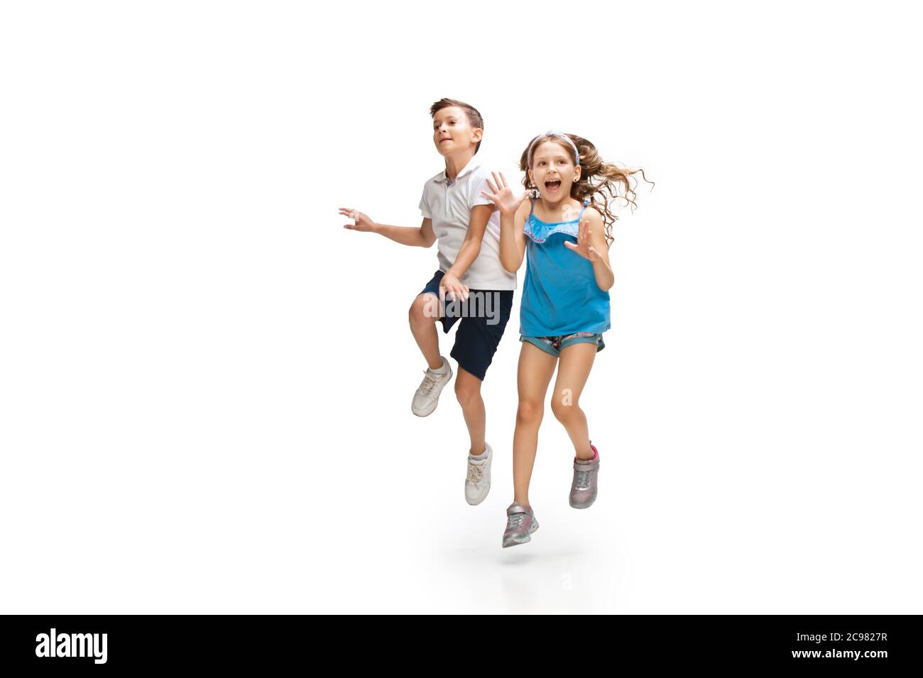 Happy kids, little and emotional caucasian boy and girl jumping and ...