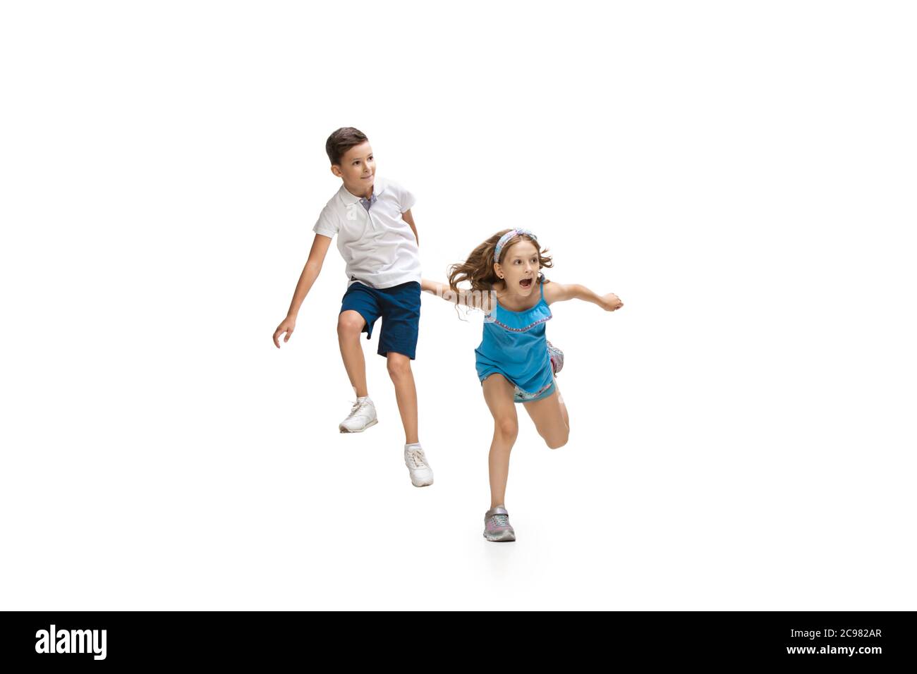 Happy kids, little and emotional caucasian boy and girl jumping and ...