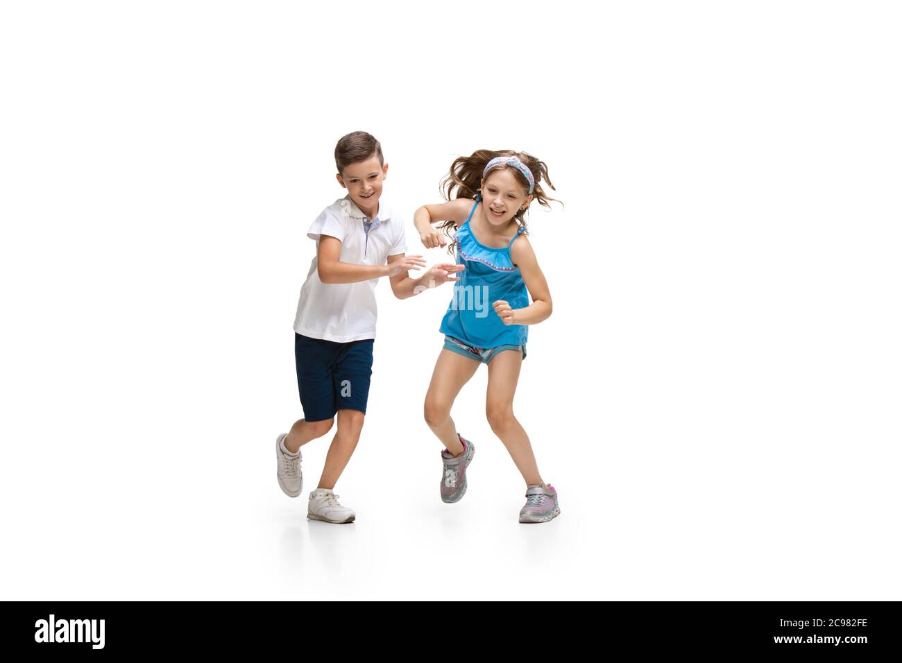 Happy kids, little and emotional caucasian boy and girl jumping and ...