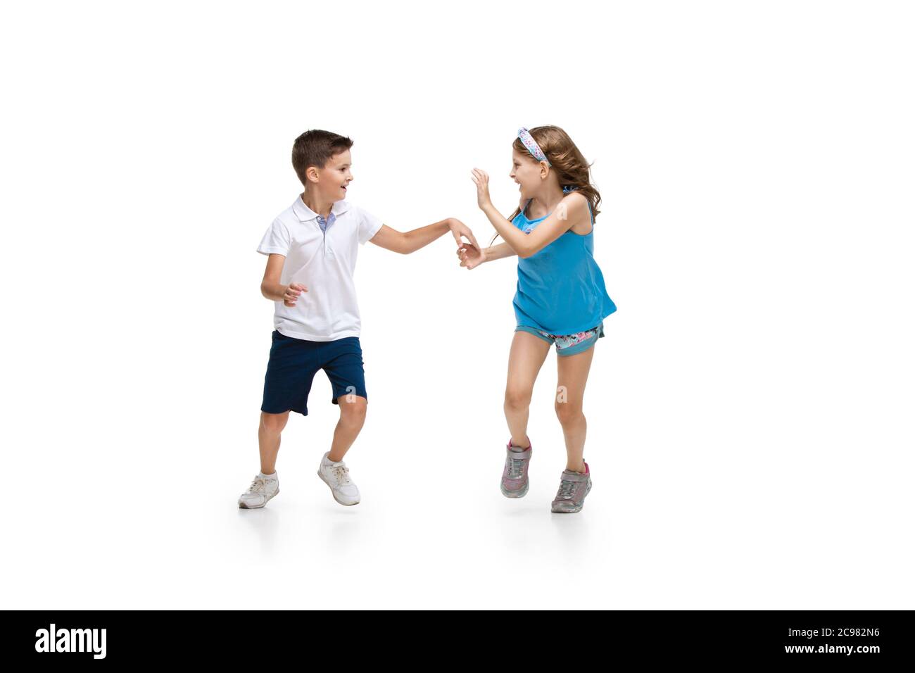 Happy kids, little and emotional caucasian boy and girl jumping and ...